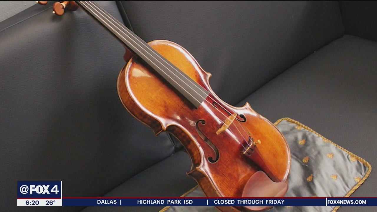 Professor snuggles with historic violin to prevent damage during North ...