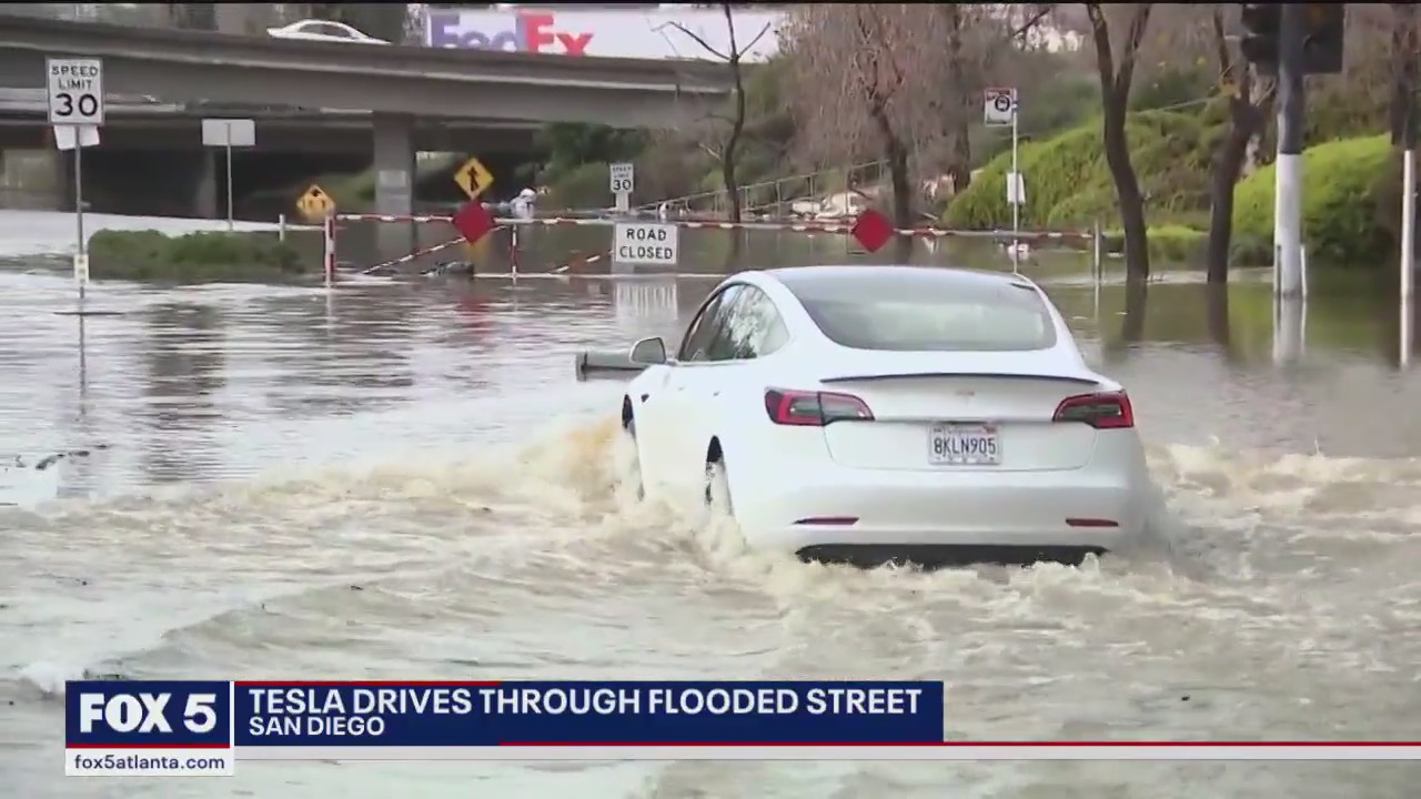Tesla drives through flooded street | FOX 5 Atlanta