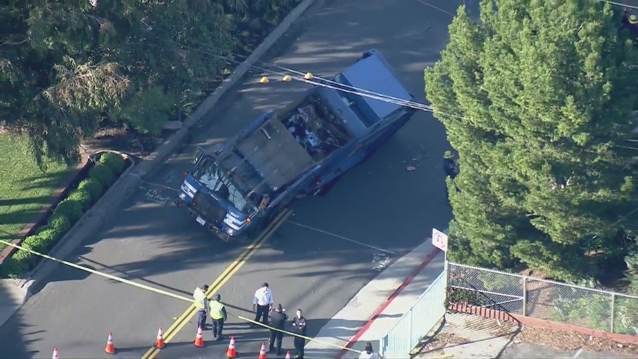 Garbage truck gets stuck in sinkhole in Torrence neighborhood | FOX 13 ...