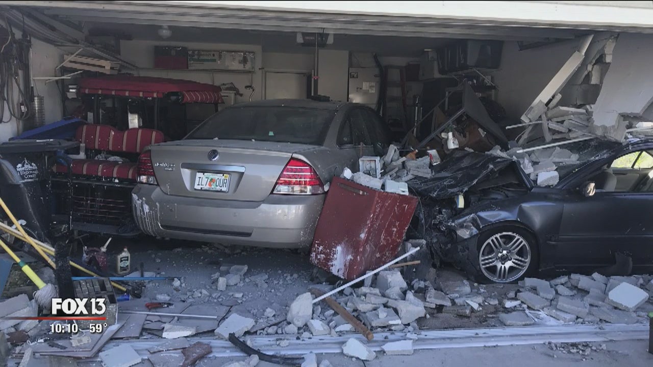 Woman rescued after crashing car into home