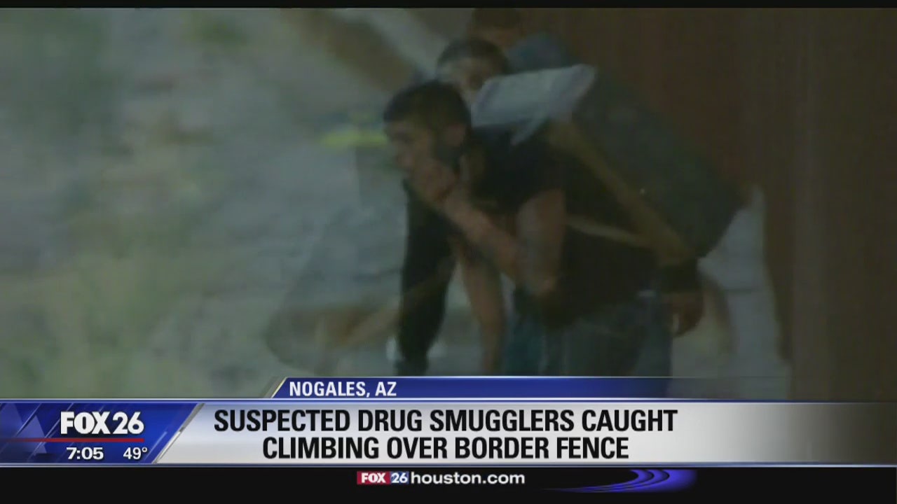 Suspected smugglers caught on video scaling US border fence