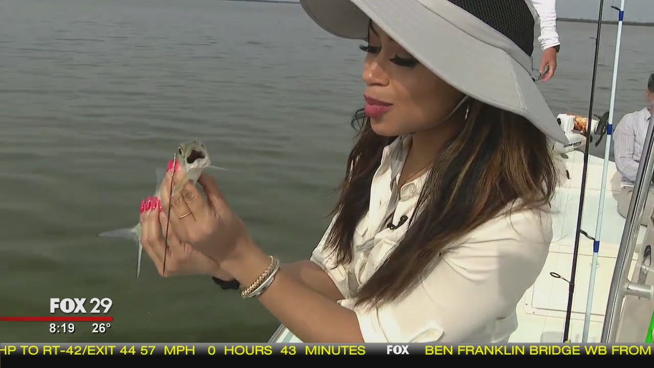 Alex Holley catches a fish in Miami