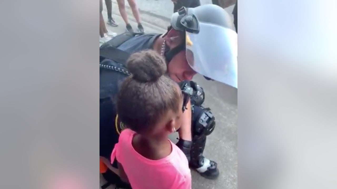 Police officer comforts crying little girl who asked 'are you gonna ...
