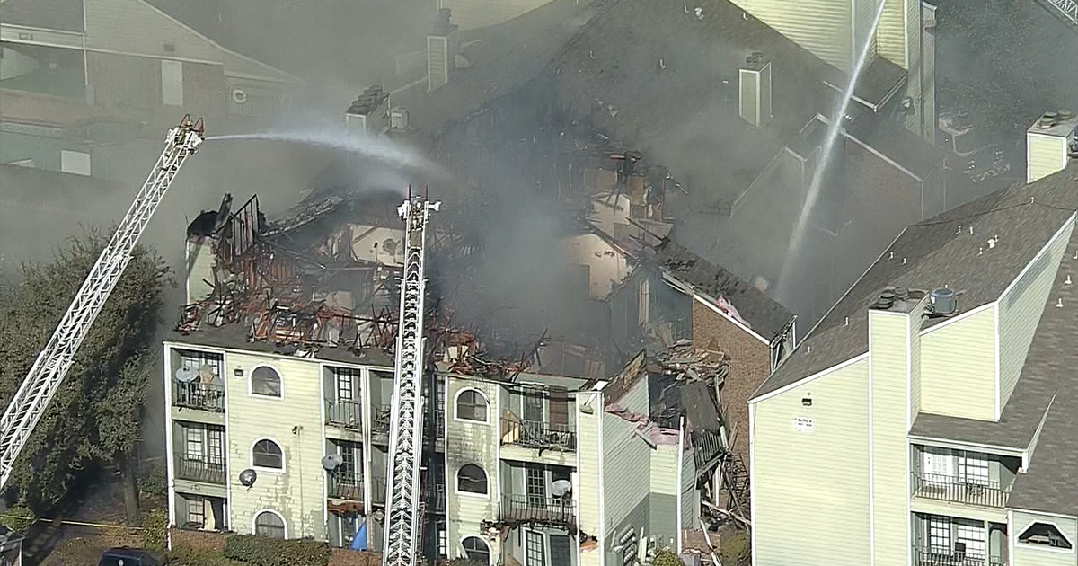 Four-alarm condo building fire burns for hours in northeast Dallas ...