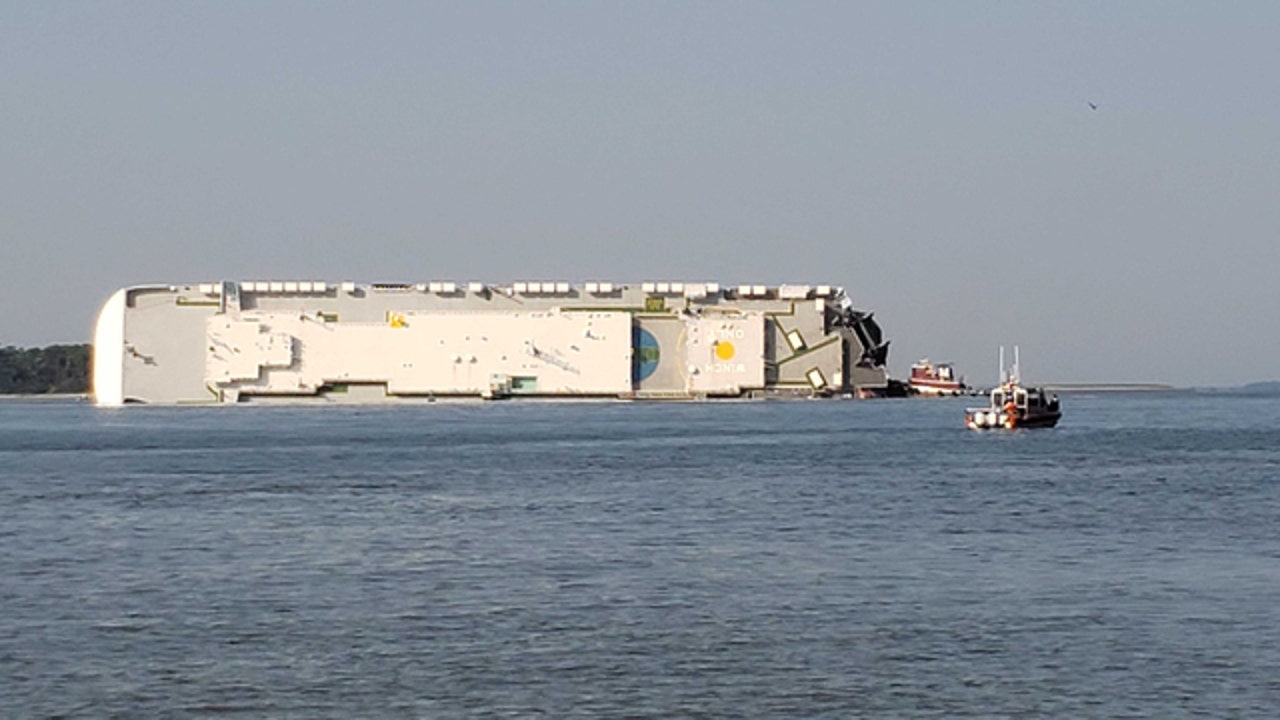 Coast Guard: 4 crew members missing from overturned cargo ship
