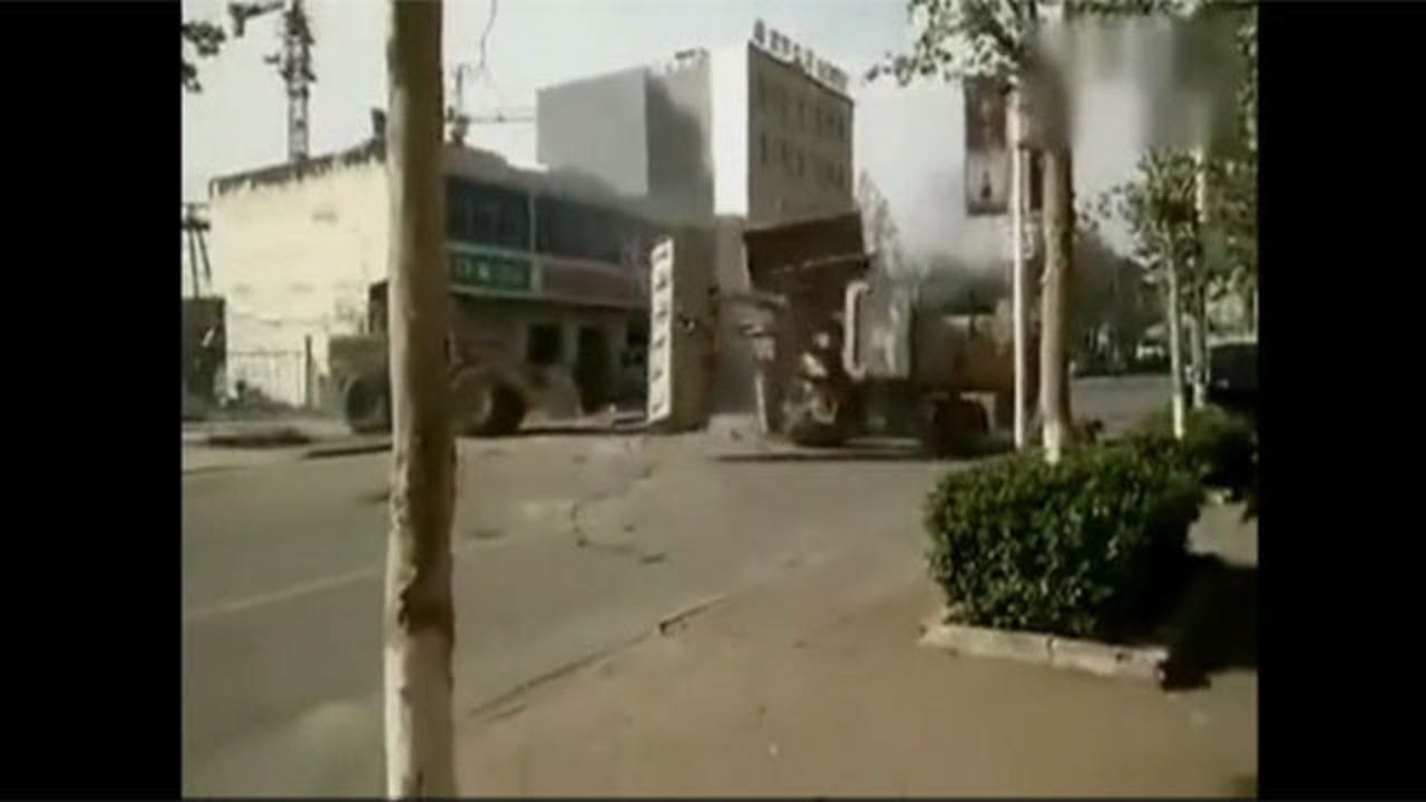 Angry Chinese construction workers duel with bulldozers