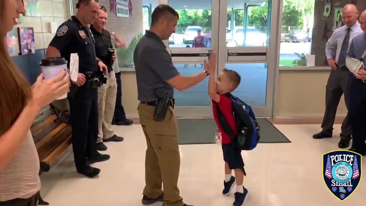 Son of fallen officer receives warm welcome from police on first day of ...