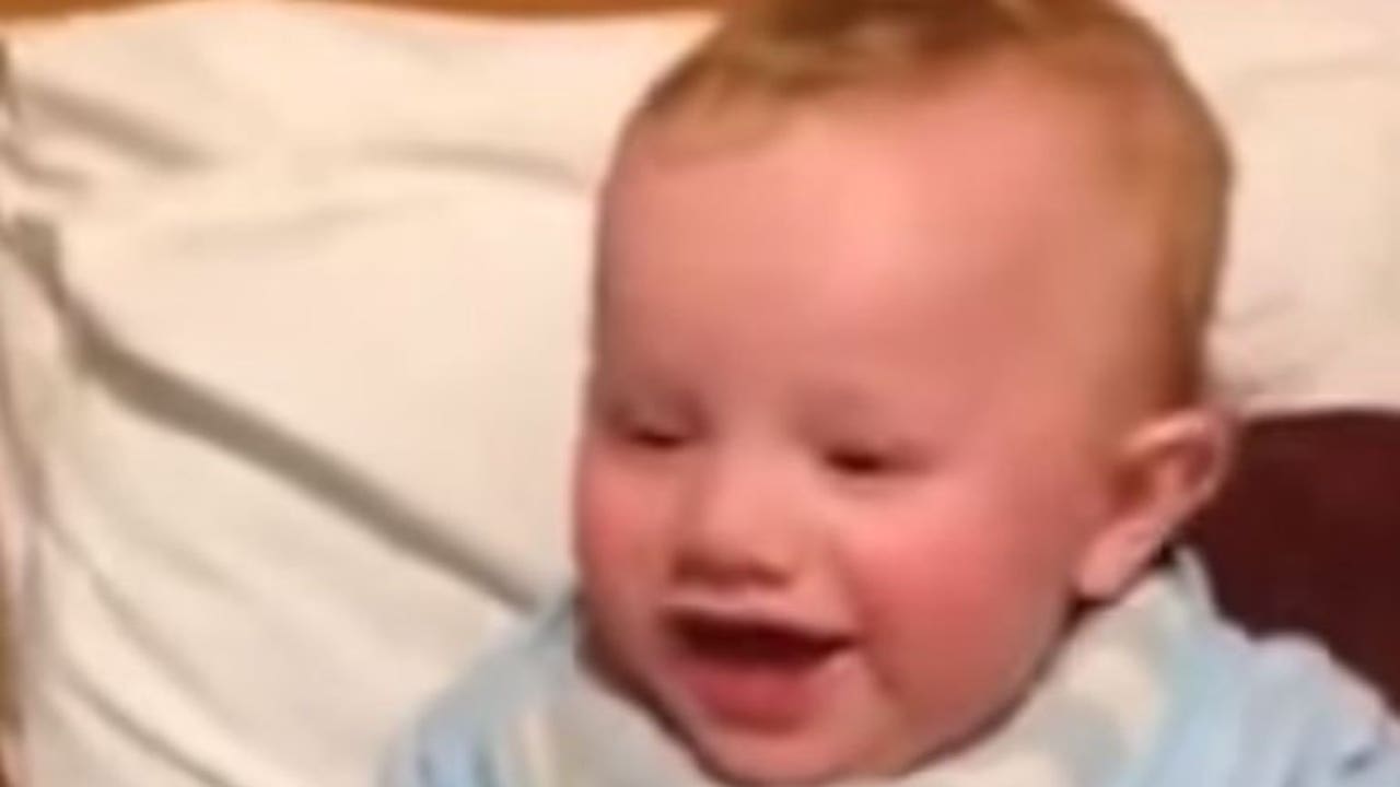 Hilarious: This baby cracking up over newspaper is sure to put a smile ...