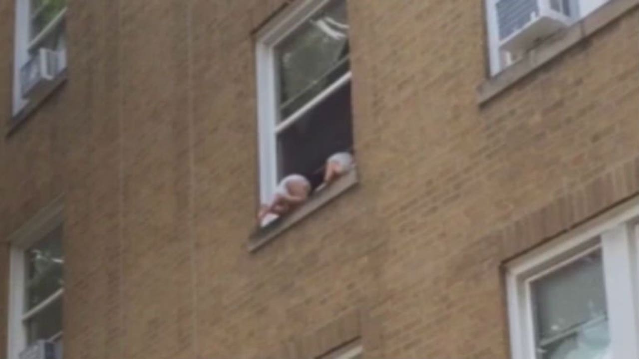 Video: Toddlers dangling from second-floor ledge make it to safety