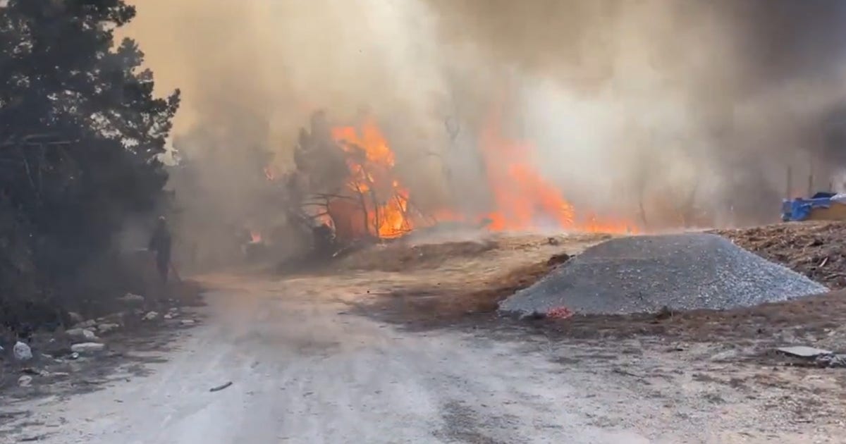 Two homes destroyed, several acres scorched by large fire in Travis ...