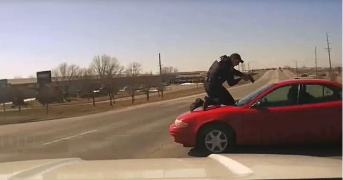 Iowa police officer clings to hood of car during dramatic chase ...