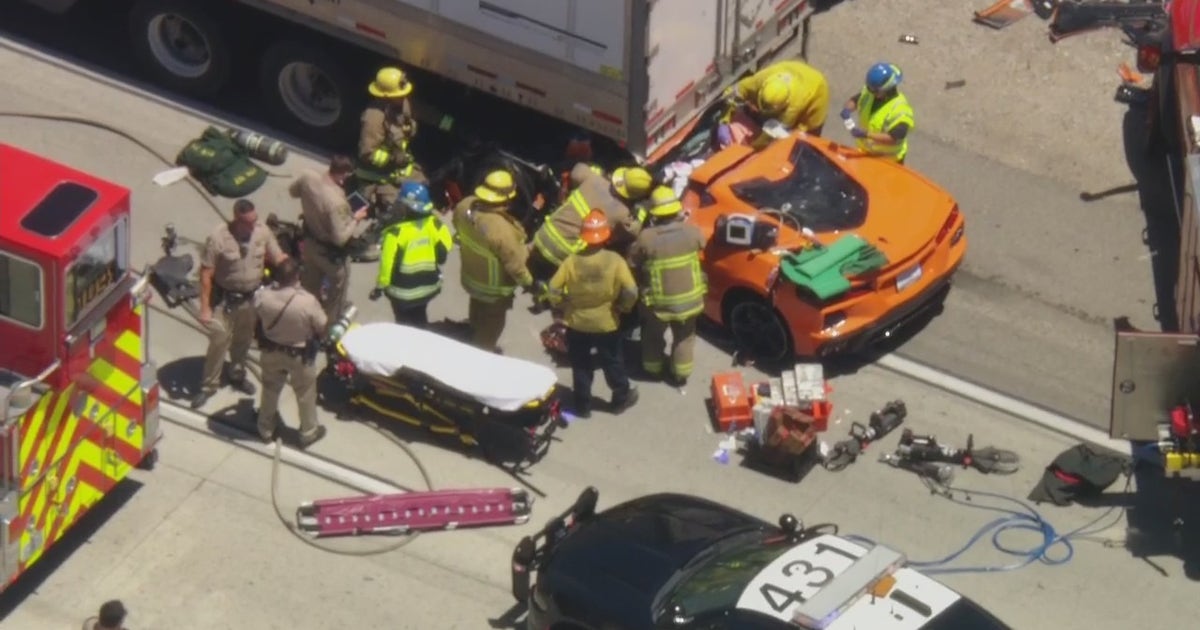 Driver injured after Corvette gets pinned under semi-truck | FOX 11 Los ...