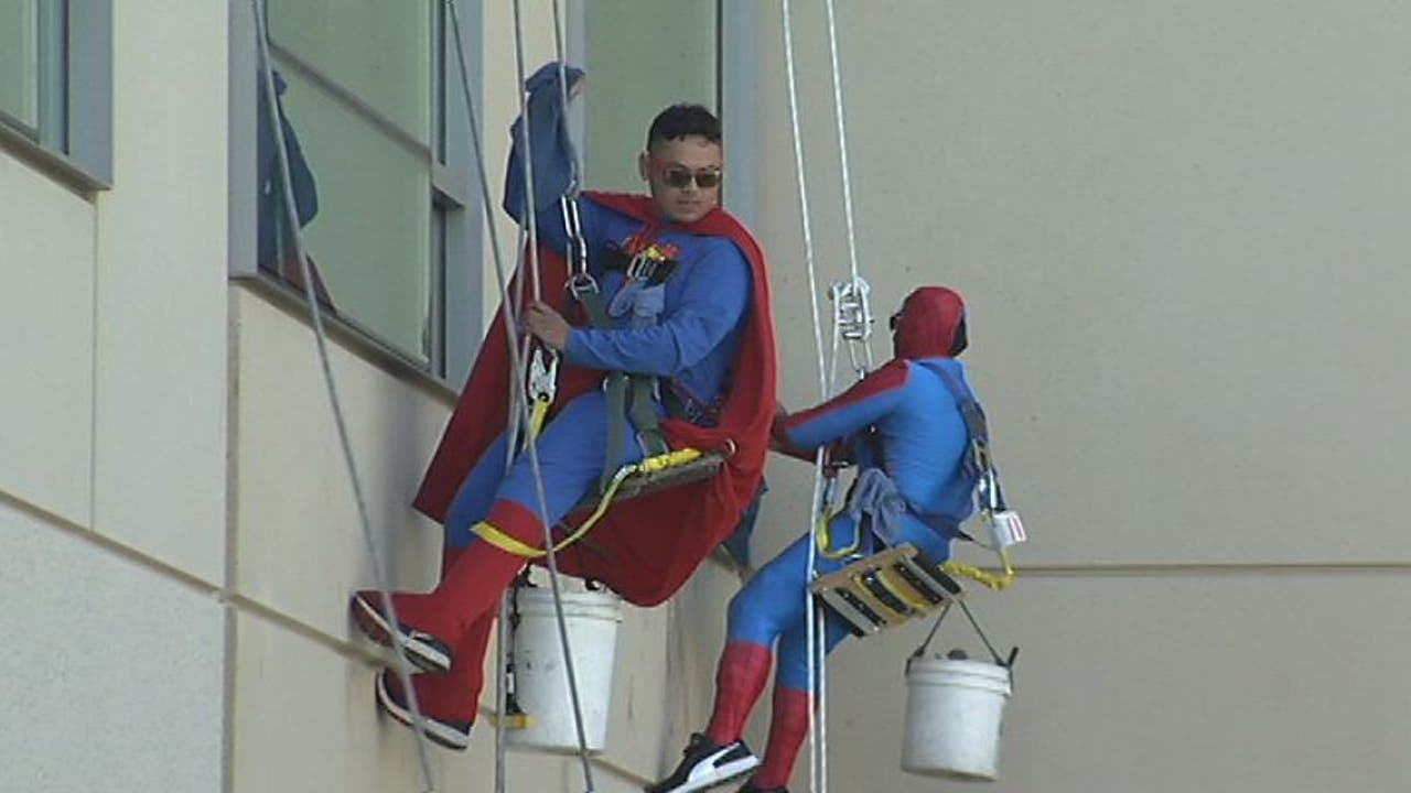 Photos: Superhero window washers give kids a treat at Children's ...
