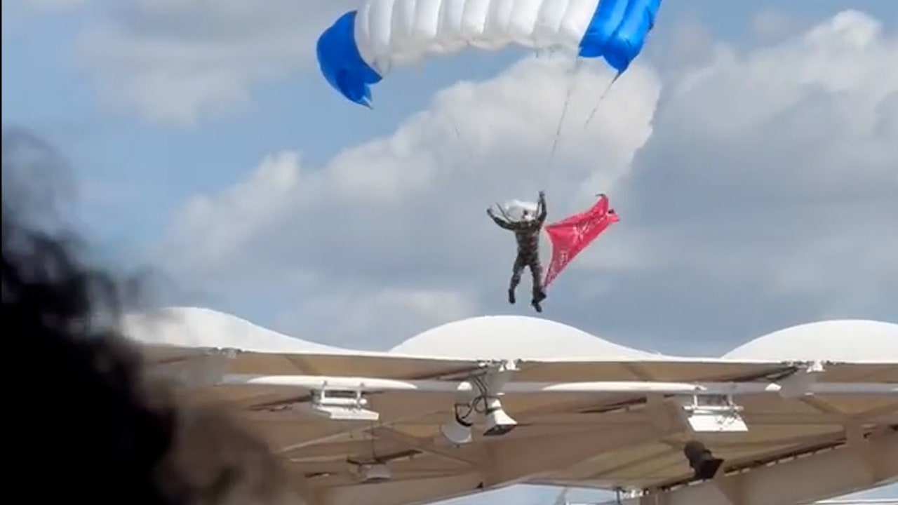 Parachutist left dangling from stadium roof as pregame stunt goes wrong ...