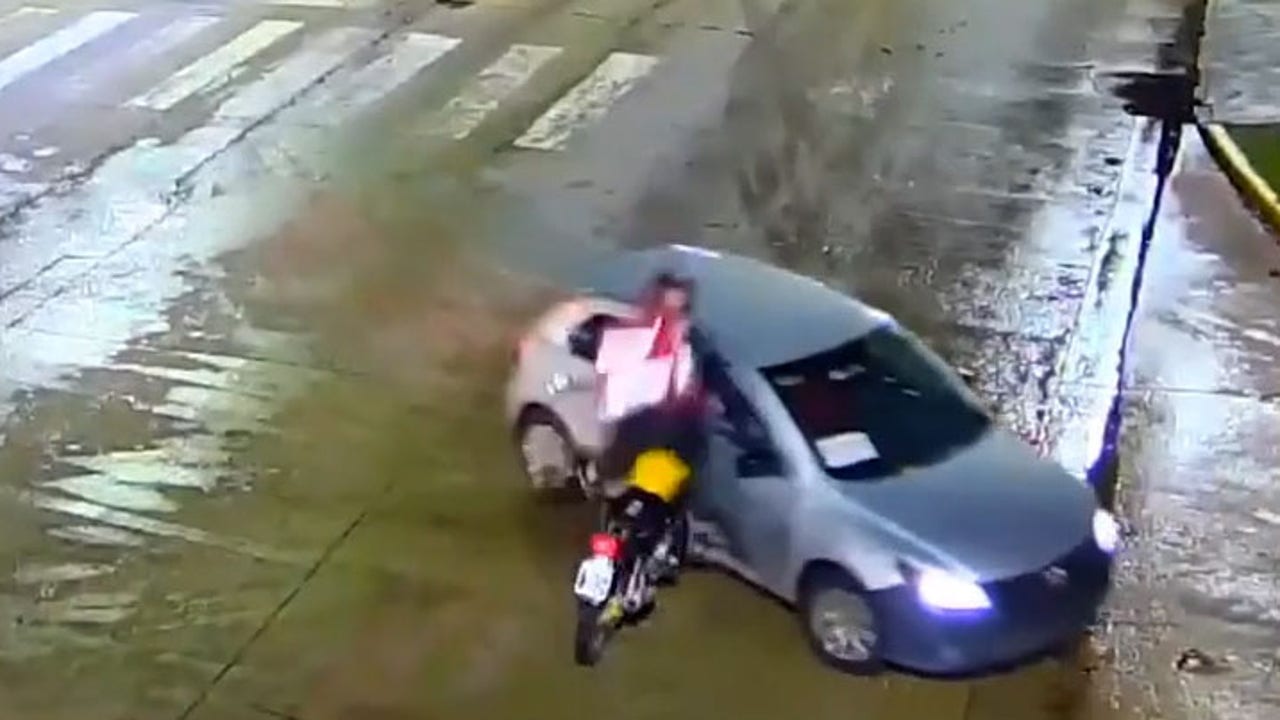 Video shows stunning motorcycle crash with rider flipping over car ...