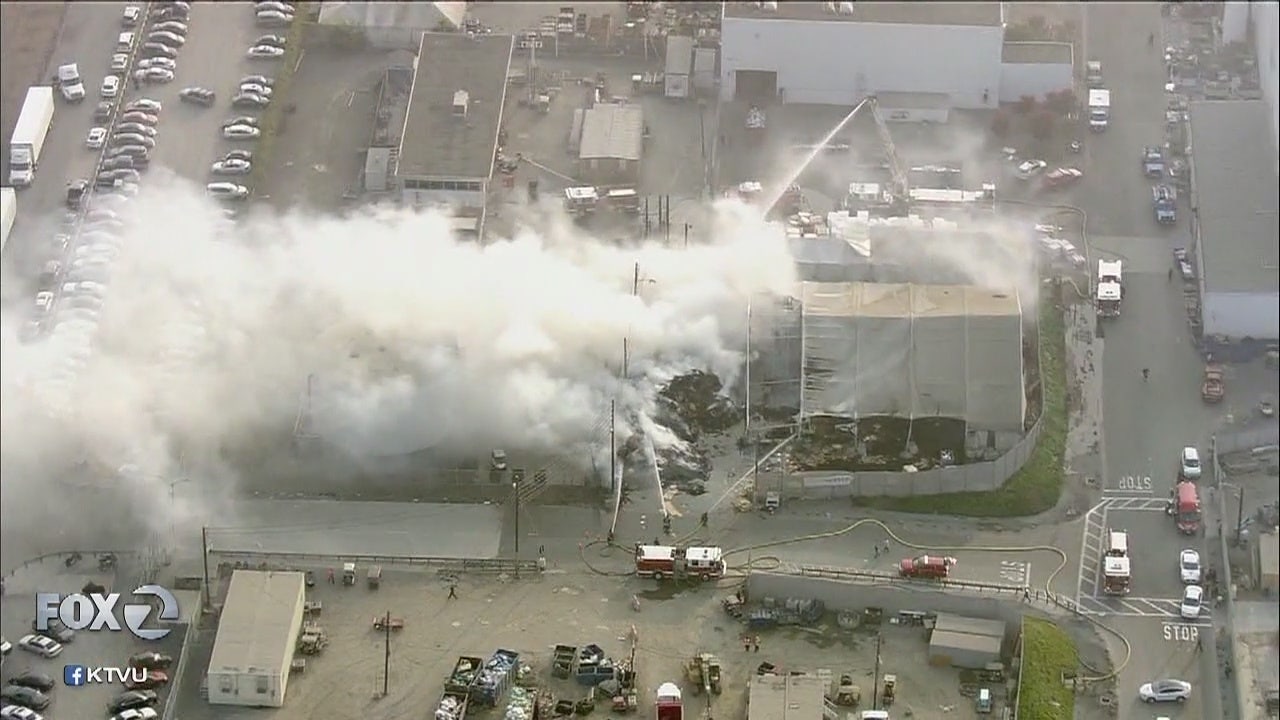 Firefighters extinguish small grass fire outside Fremont Tesla plant ...
