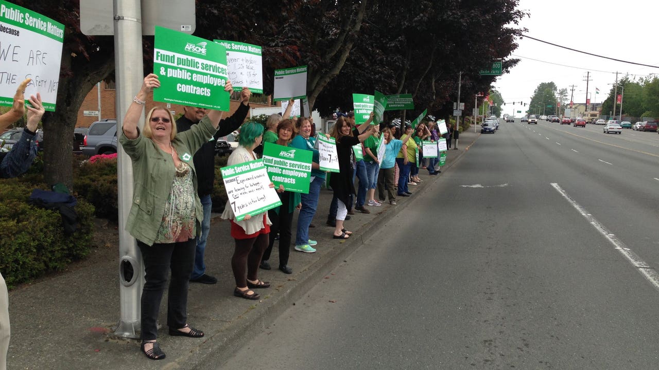 Thousands of state employees walk off job, picket for better pay as ...