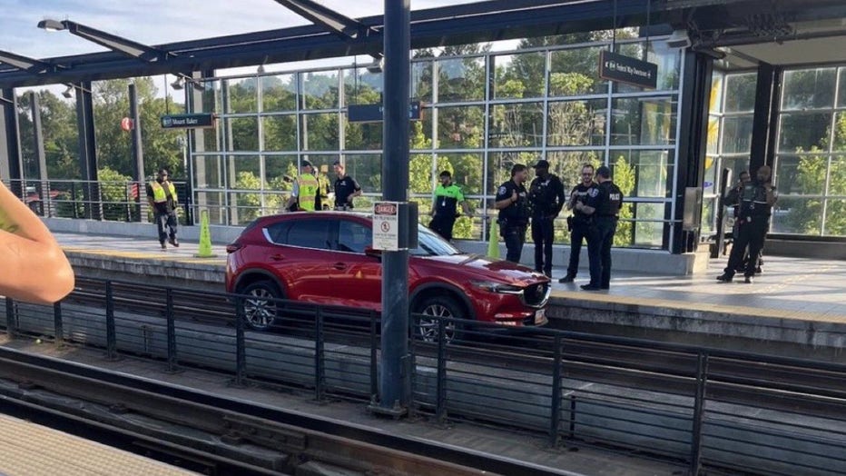 Car drives onto light rail tracks, disrupting service | FOX 13 Seattle